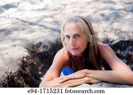 Portrait of a 57 year old woman on a beach smiling at the camera Stock ...