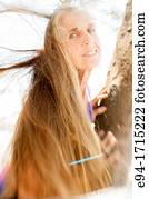 Portrait of a 57 year old woman on a beach smiling at the camera Stock ...