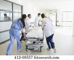 Doctors rushing patient on gurney in hospital corridor Stock Image ...