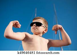 Little boys flex their bicep muscles at the beach. Delaware, USA ...