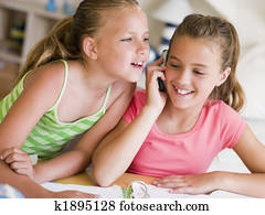 Young Girls Distracted From Their Homework, Talking On A Cellphone ...