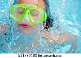Pretty young girl in swimming pool laughing with Swim Goggles Stock ...