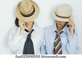 Teenage girl pulling hat down over eyes, portrait Stock Photography ...
