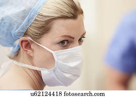 Surgeon wearing surgical mask in operating room Stock Photography ...
