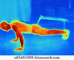 Thermal image of athlete training on exercise machine. Image shows the ...
