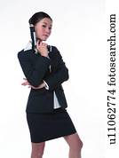 Young woman in business suit, holding gun, shooting, front view Stock ...