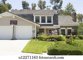 Middle aged couple standing outside house Stock Photograph | is098r3r6 ...