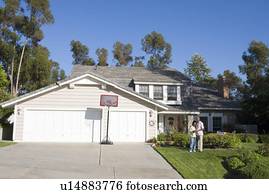Middle aged couple standing outside house Stock Photograph | is098r3r6 ...
