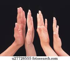 Four people holding hands in field (rear view, silhouette) Stock Image ...